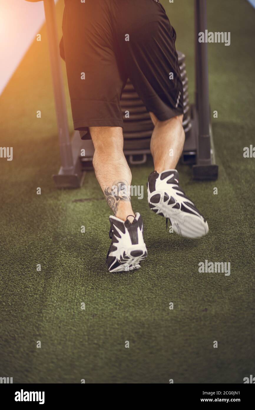 sled push man pushing weights workout exercise at gym Stock Photo - Alamy