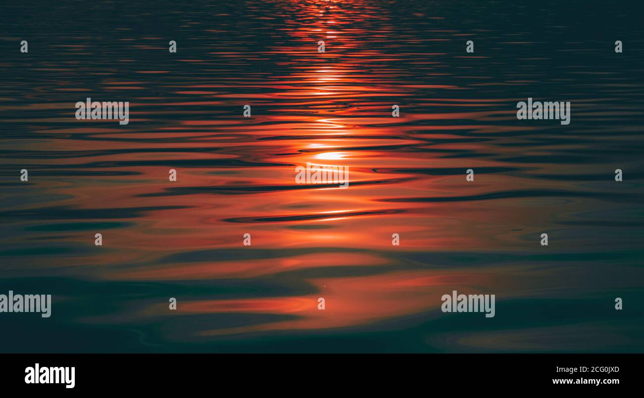 Reflection of the sun in water, sun lane in dusk waves Stock Photo - Alamy