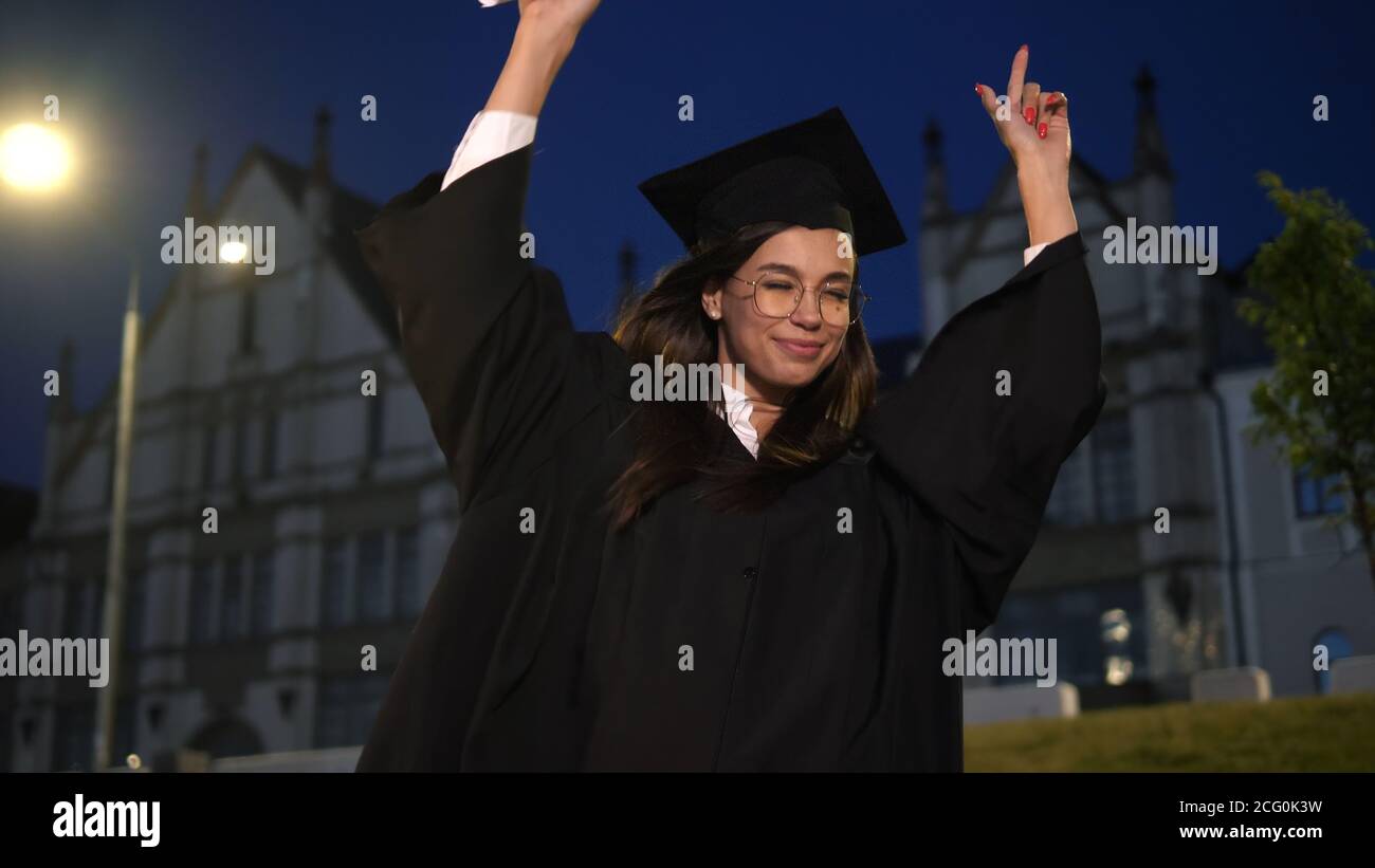 The cute woman graduate dancing Stock Photo - Alamy