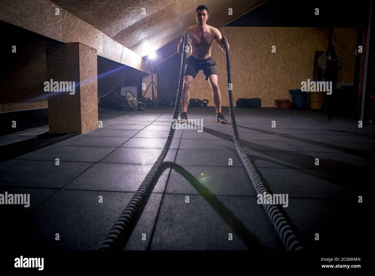 Concept: power, strength, healthy lifestyle, sport. Powerful attractive muscular man Cross Fit ...