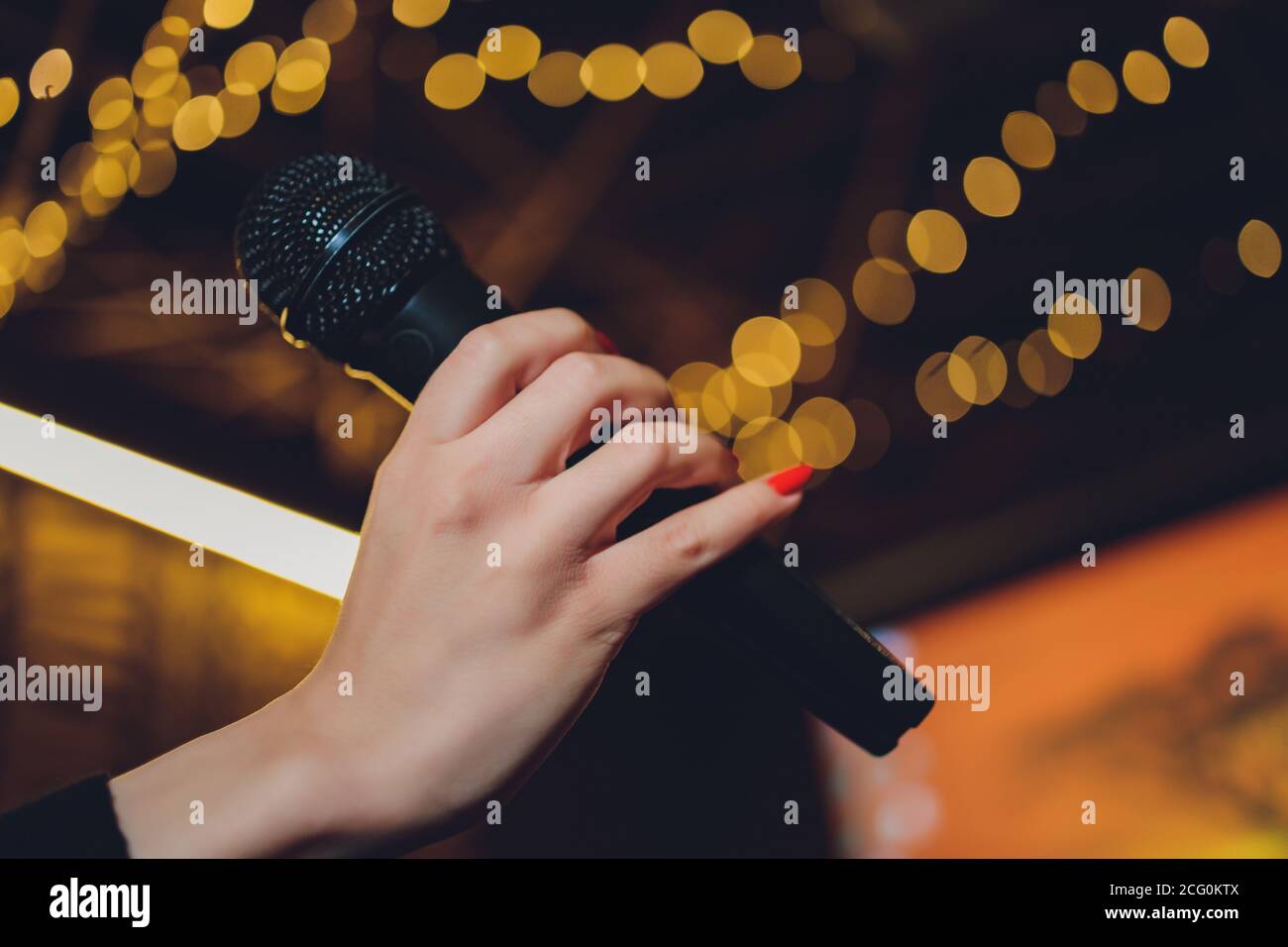 Microphone and female singer close up. Woman singing into a microphone ...