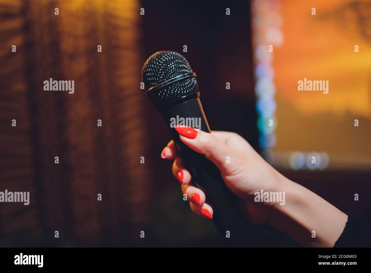 Microphone and female singer close up. Woman singing into a microphone ...