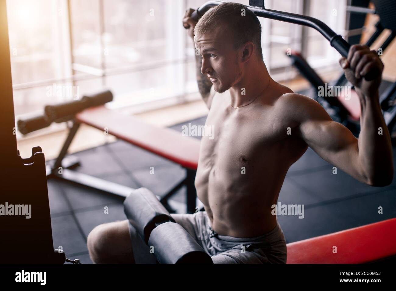 Shoulder pull down machine. Fitness man working out lat pulldown ...