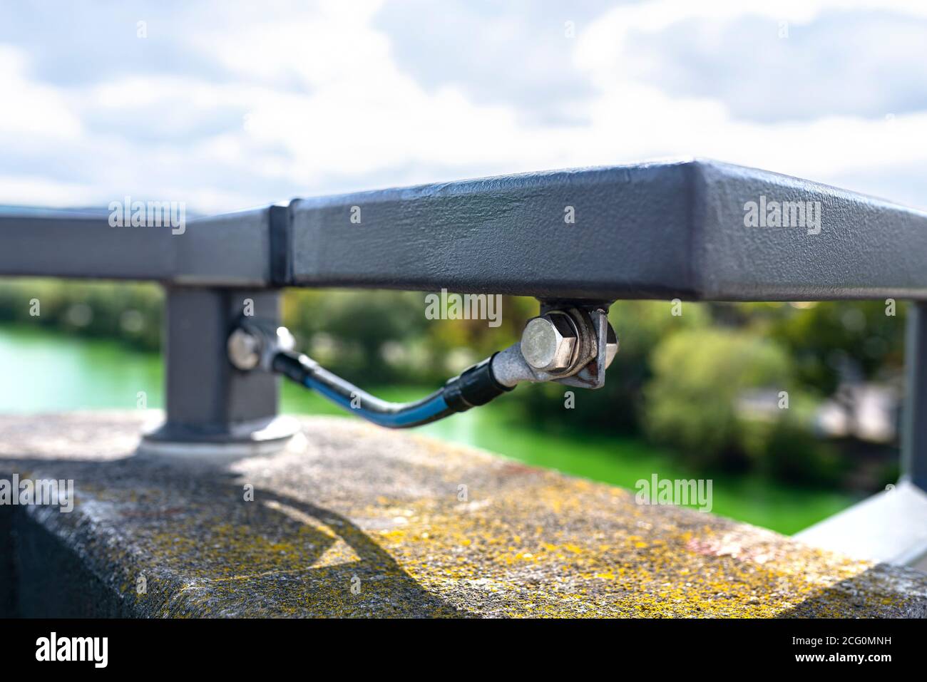 A grounding cable connecting the metal railings on the railway bridge ...