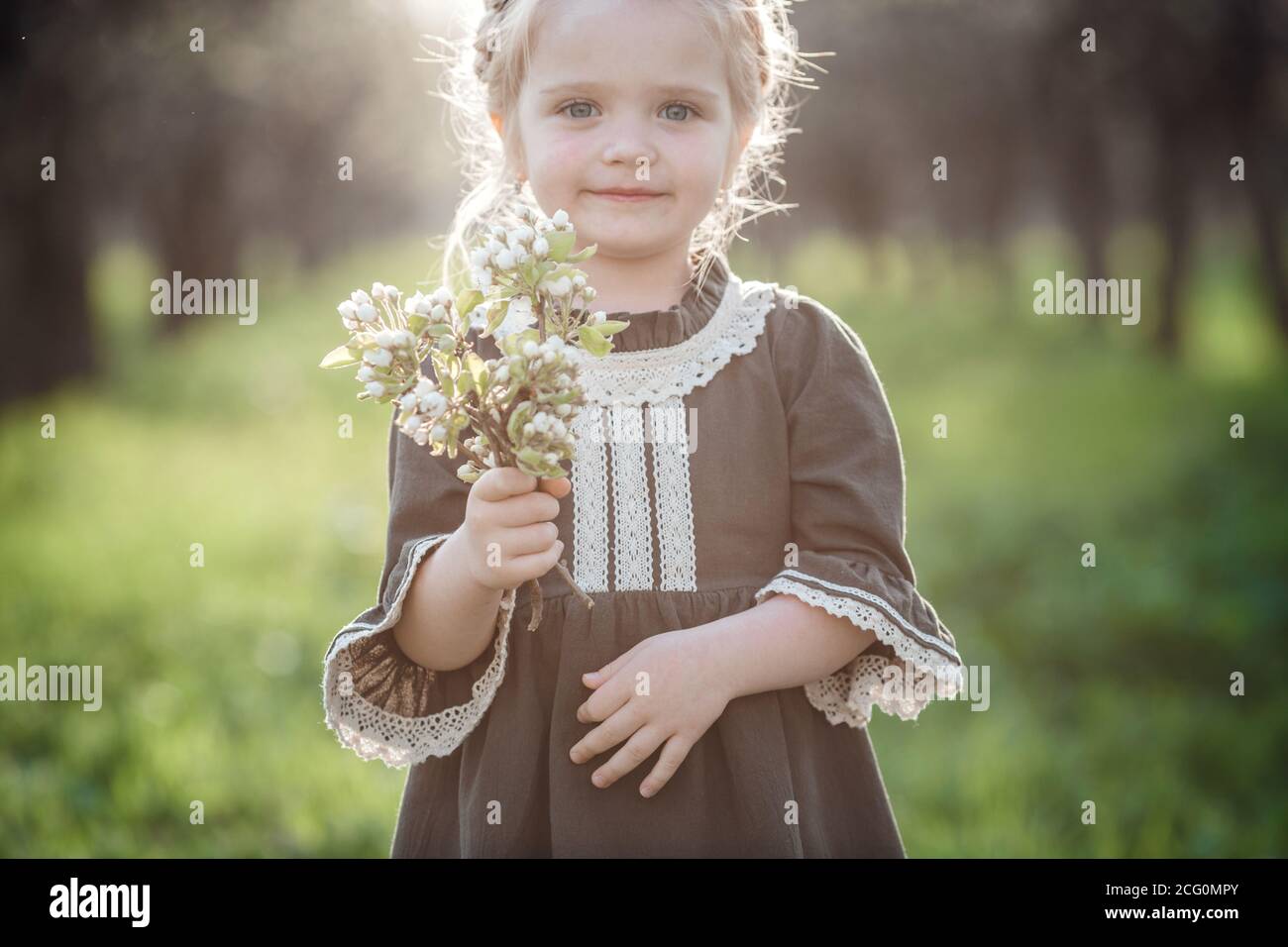 small cute girl in dress in blossom garden. Cute baby girl 3-4 year old ...