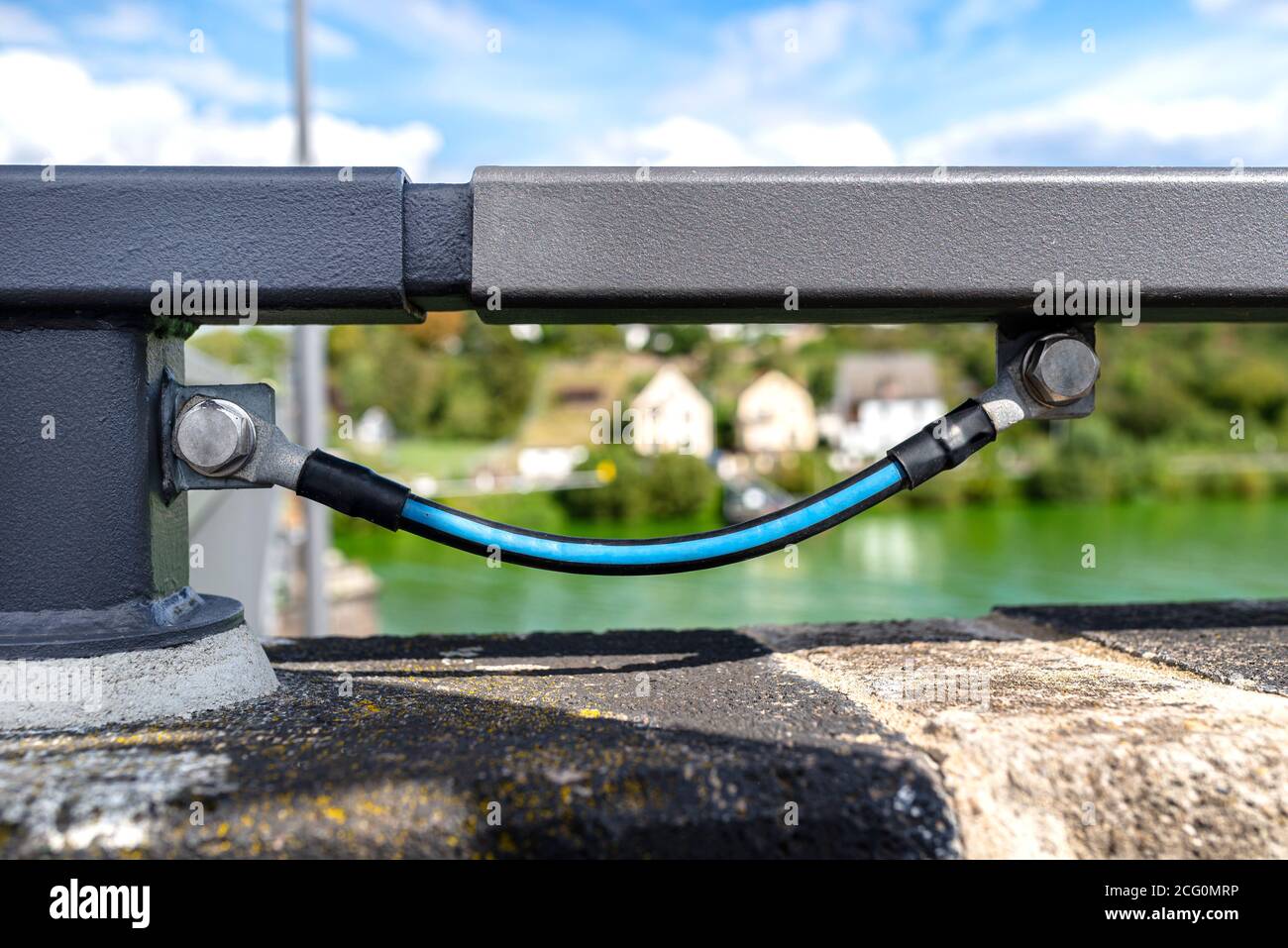 A grounding cable connecting the metal railings on the railway bridge ...