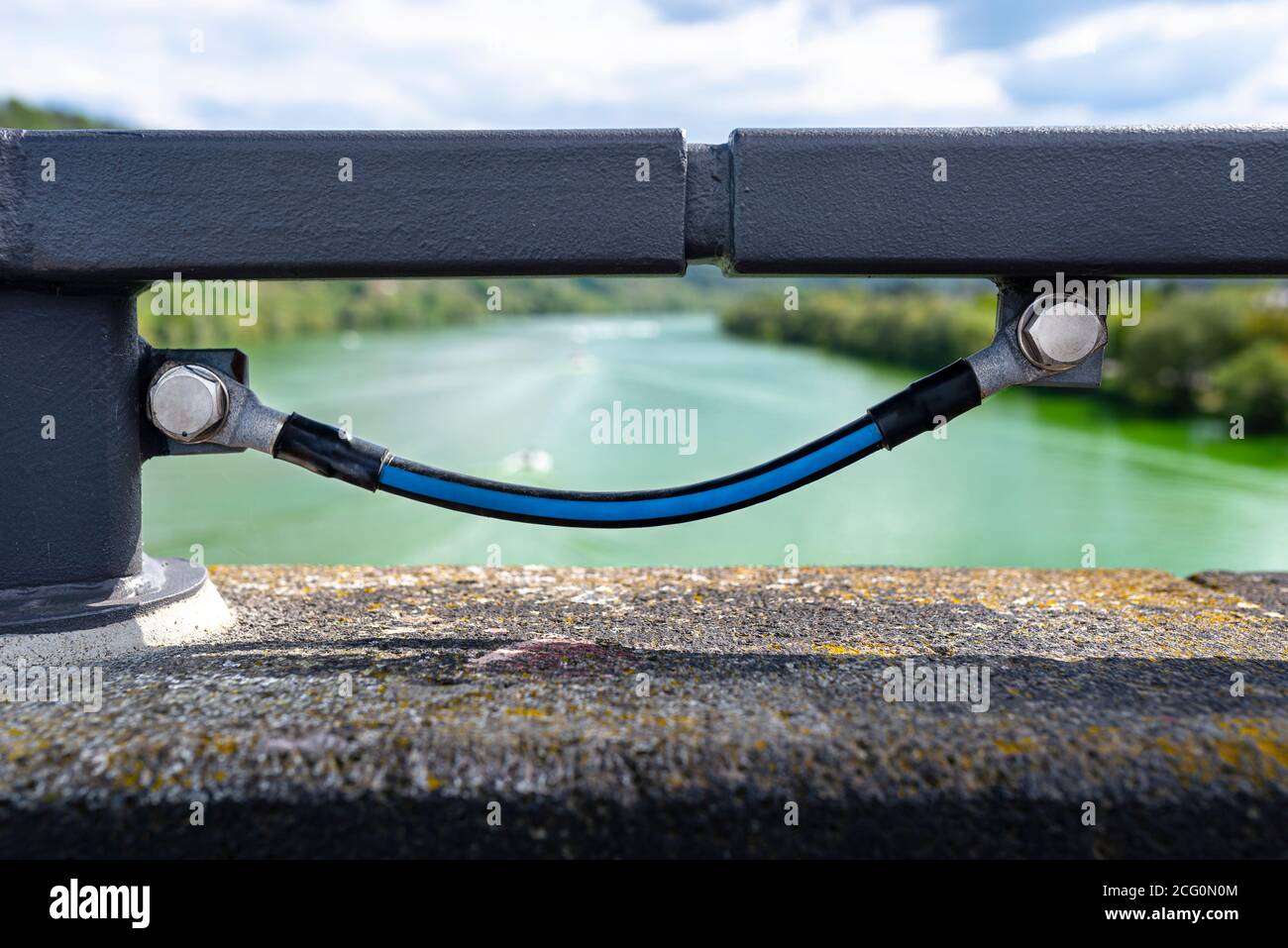 A grounding cable connecting the metal railings on the railway bridge ...