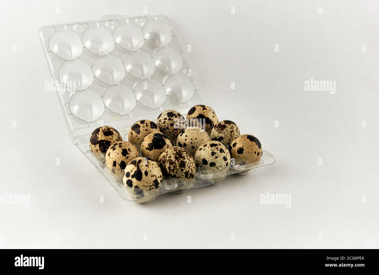 Quail eggs alignment in a plastic box Stock Photo - Alamy