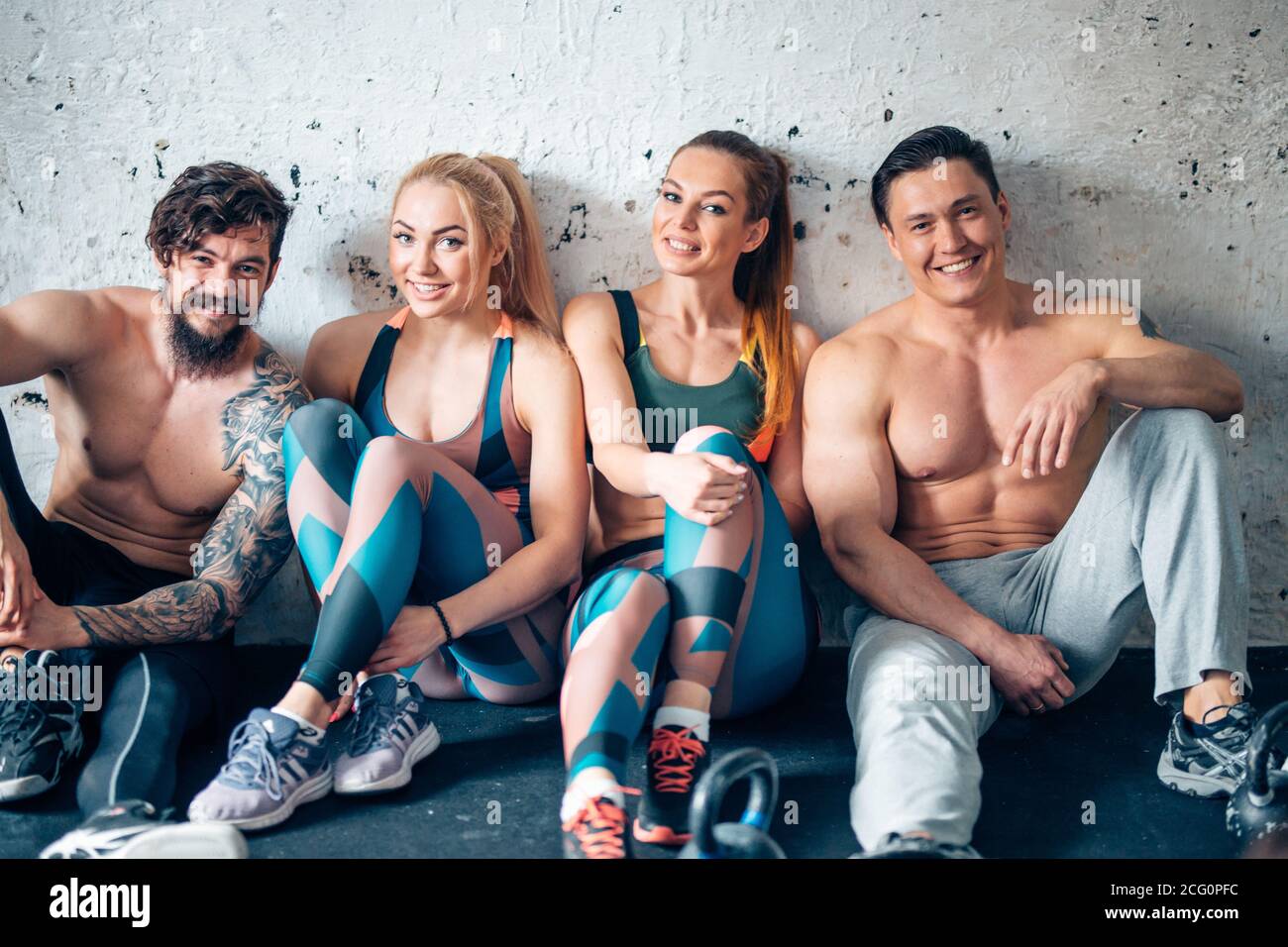 fitness models resting in the gym after workout Stock Photo - Alamy
