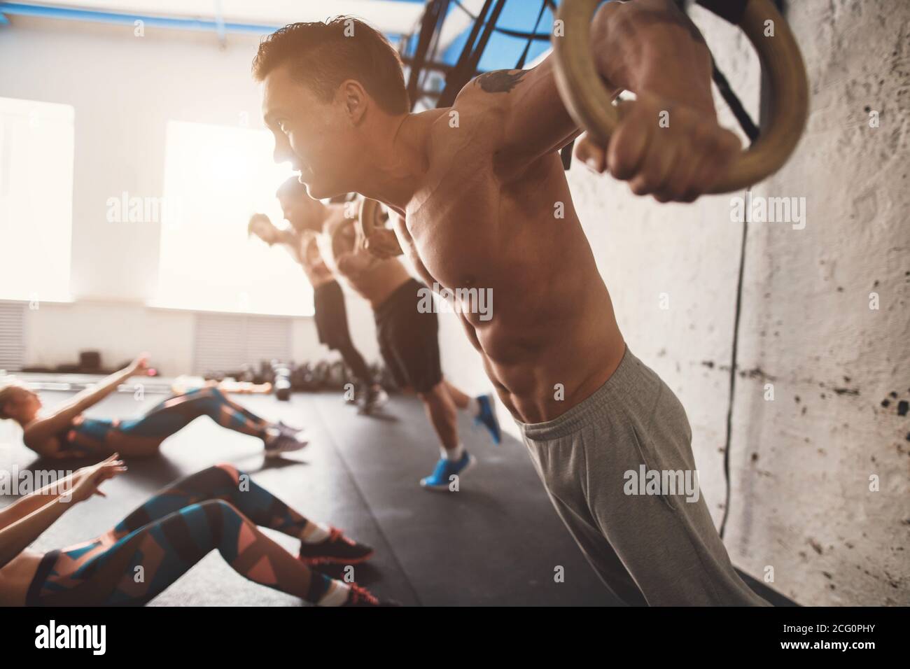 dip ring group workout at gym dipping in a row exercise Stock Photo - Alamy
