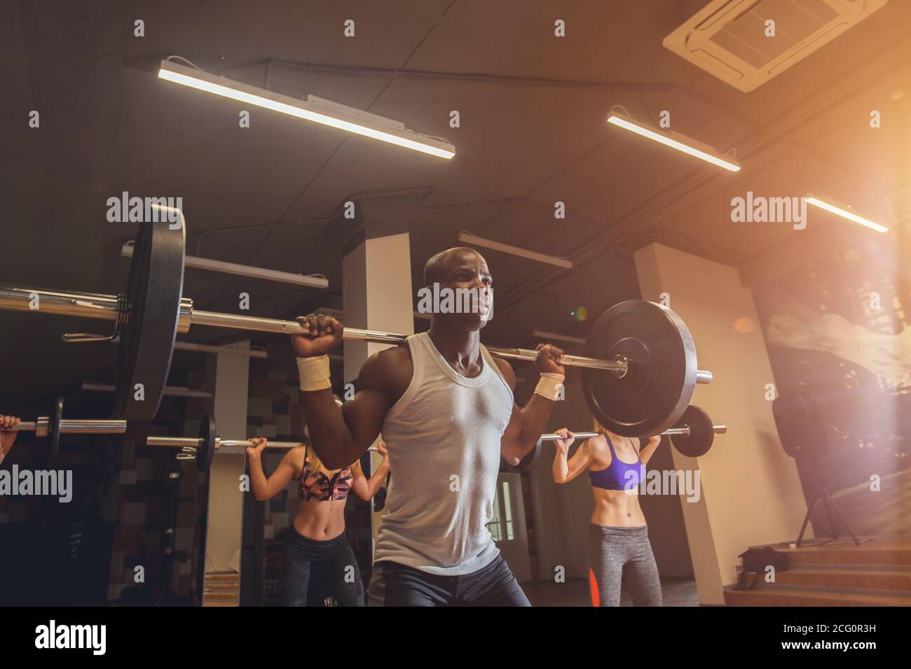 Athletes friends training with barbells inside gym club - Young people ...