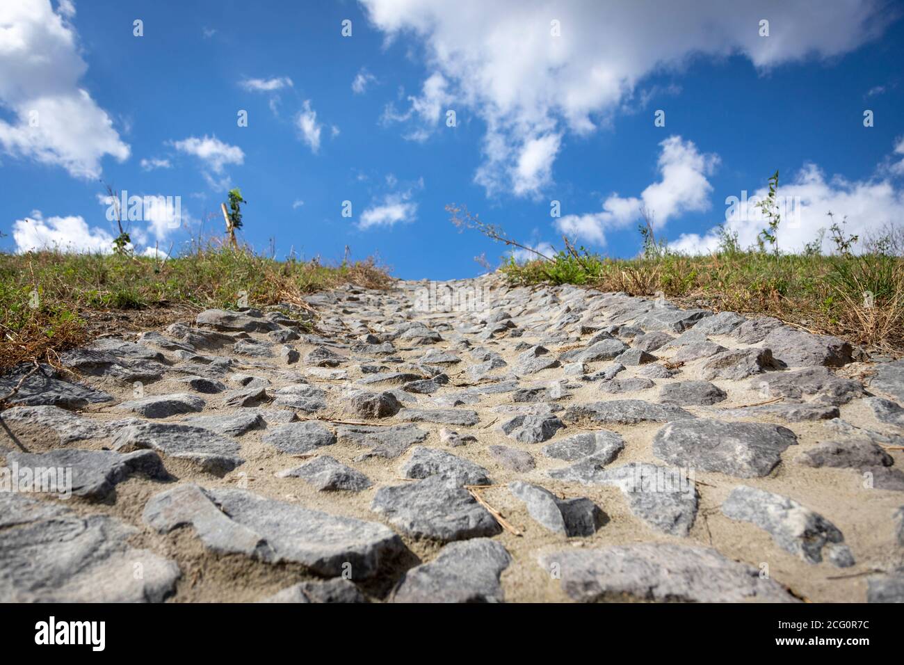 stone way up the hill, blue sky with clouds in the background, outdoors ...