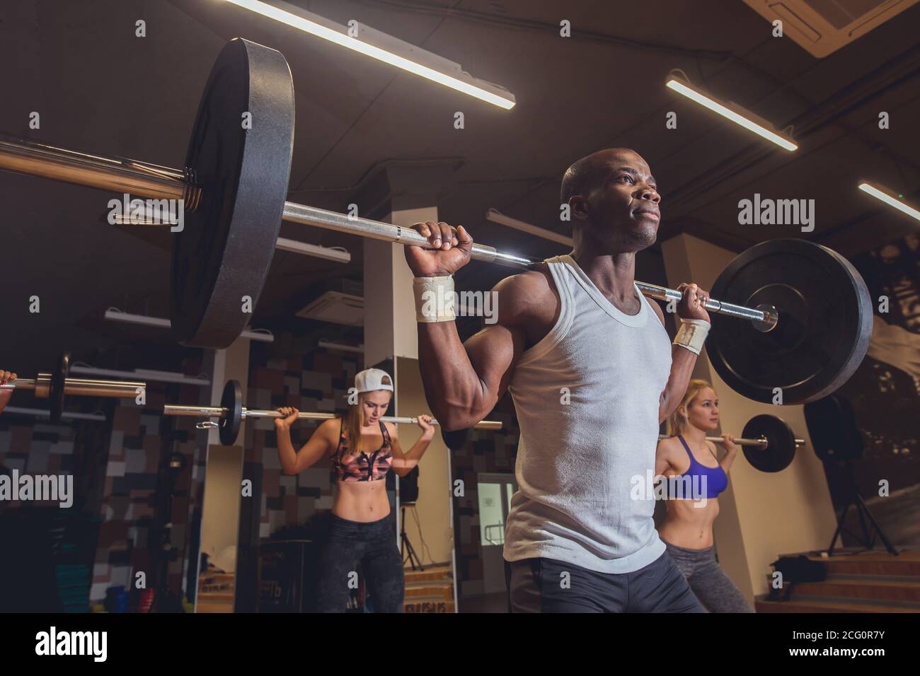 Athletes friends training with barbells inside gym club - Young people ...