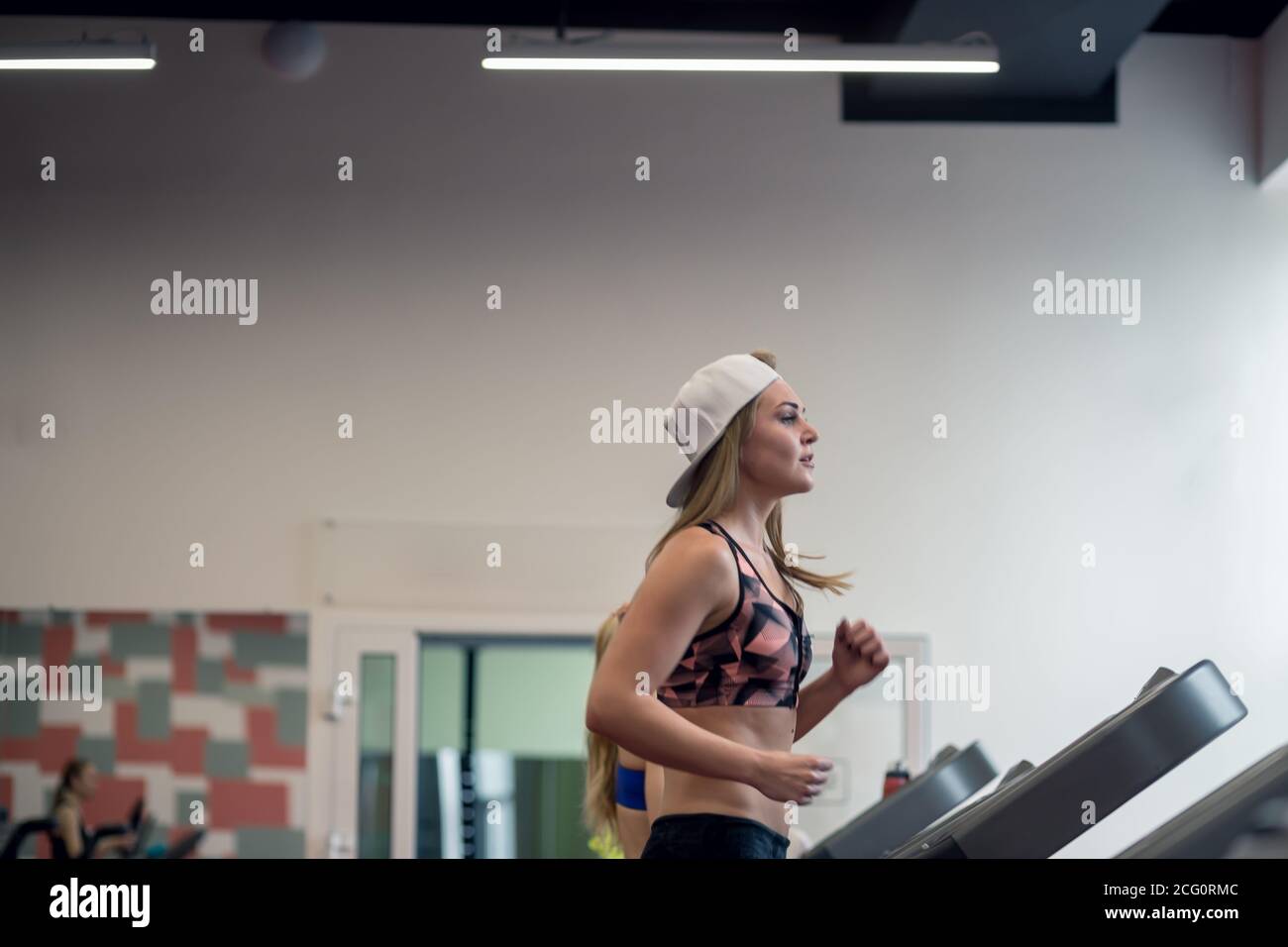 People running in machine treadmill at fitness gym club Stock Photo - Alamy