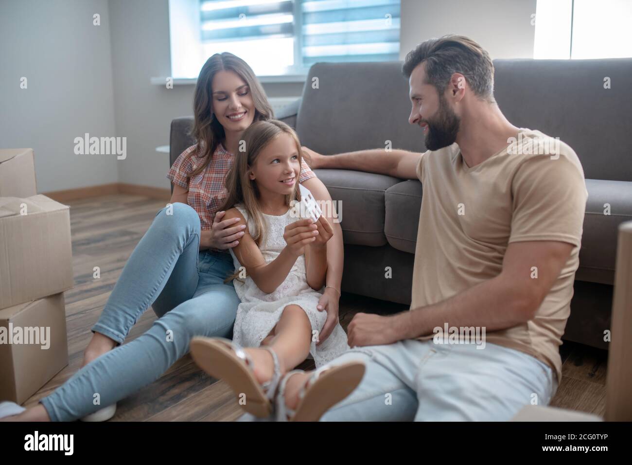 Cute child showing a house miniature to her father Stock Photo - Alamy
