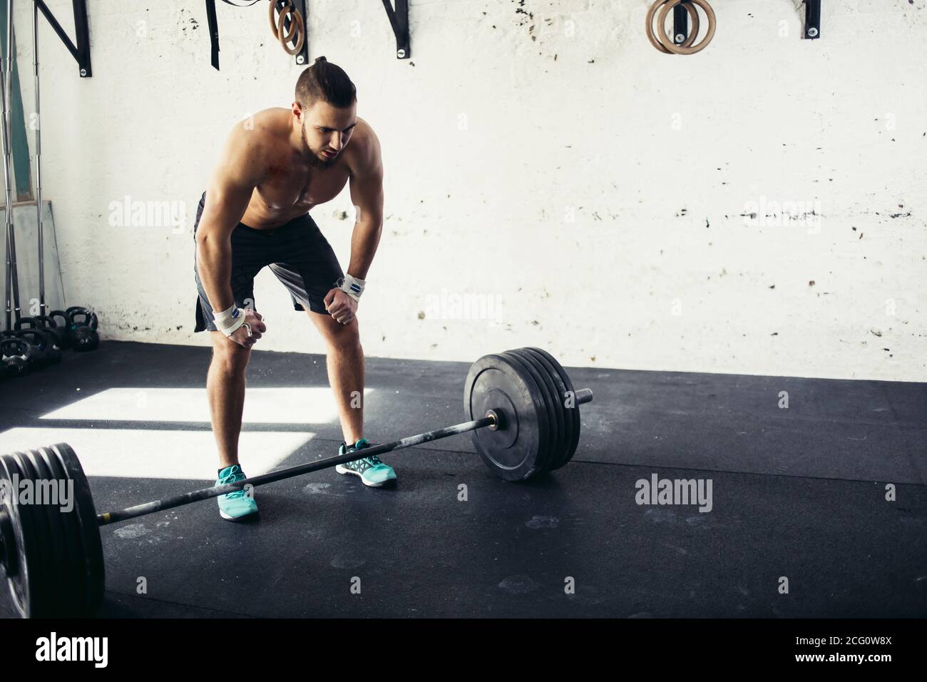 Exhausted athlete resting after heavy barbells training Stock Photo - Alamy