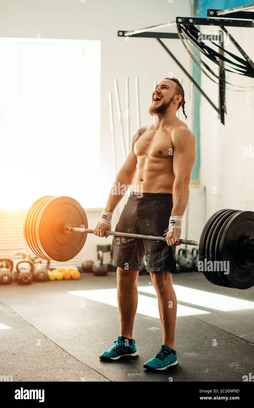 strong crossfit athlete in the middle a heavy snatch lift in a cross ...