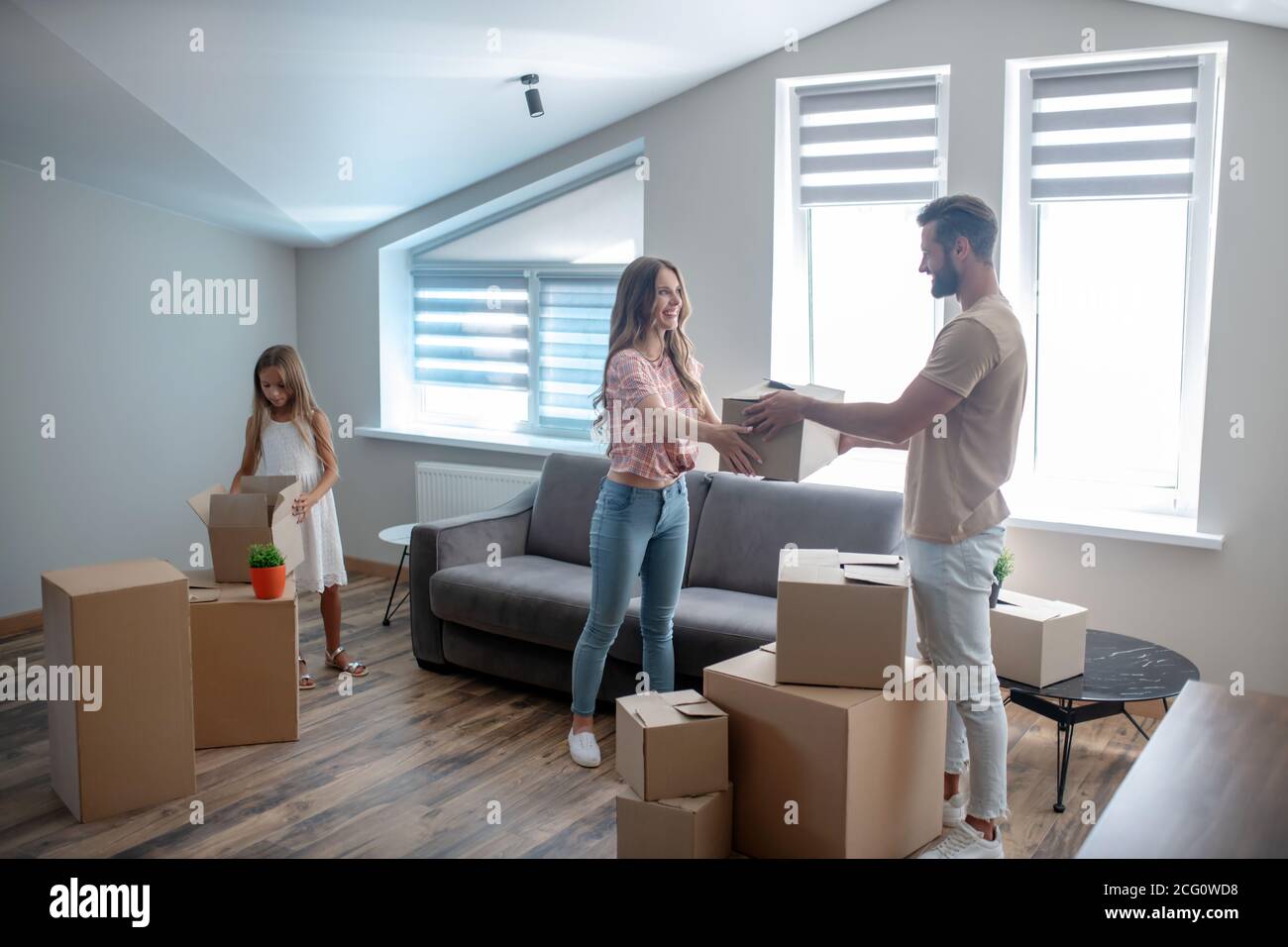 Family unpacking their stuff in a new house Stock Photo - Alamy