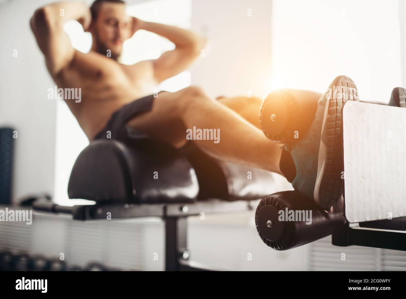Muscular man exercising doing sit up exercise. Athlete with six pack ...