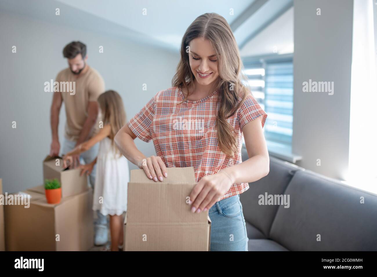 Family unpacking their stuff in a new house and looking excited Stock ...