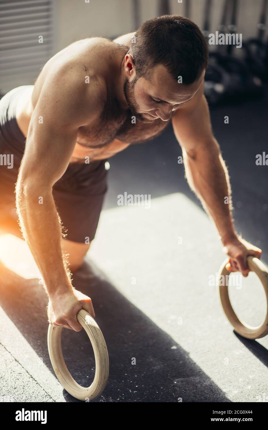 Push up with gymnastic rings in fitness gym Stock Photo - Alamy