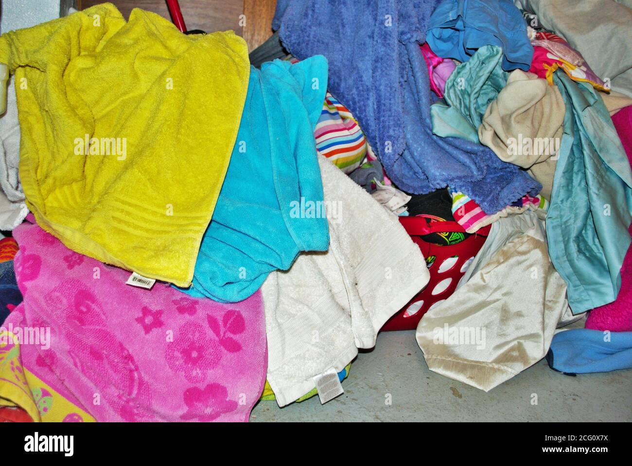 Pile of dirty towels that need to be washed in a basement laundry room ...