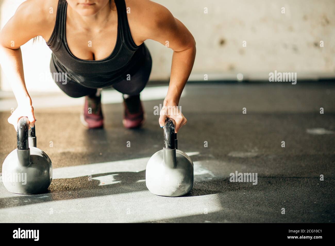 Young strong girl doing push-ups on kettlebells Stock Photo - Alamy