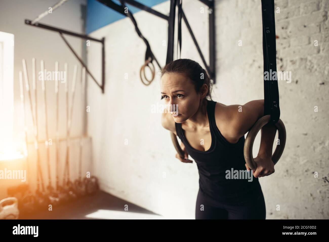 Dip ring woman workout at gym dipping exercise Stock Photo - Alamy