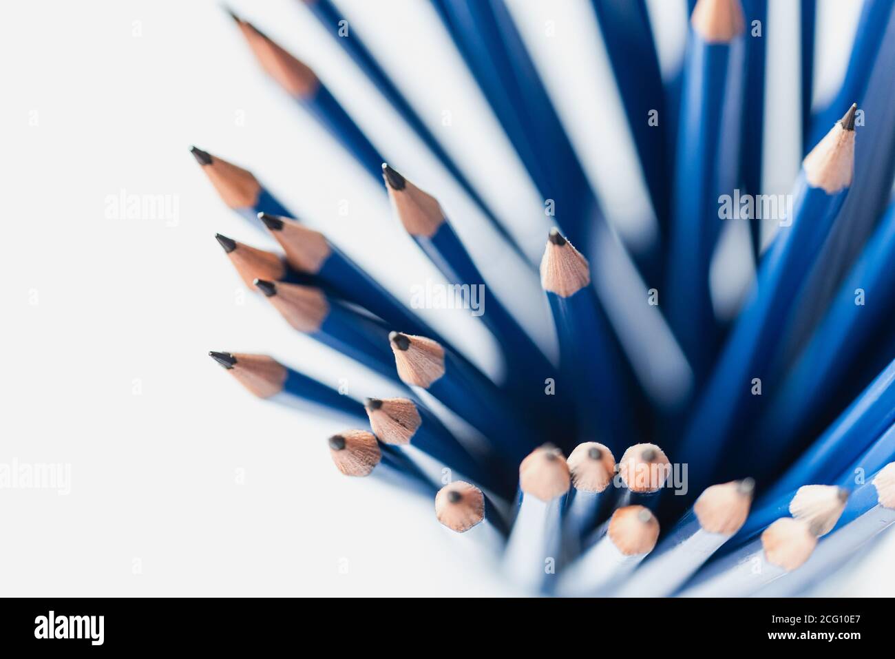 Overhead view of bunch of sharpened blue pencils on white paper Stock ...
