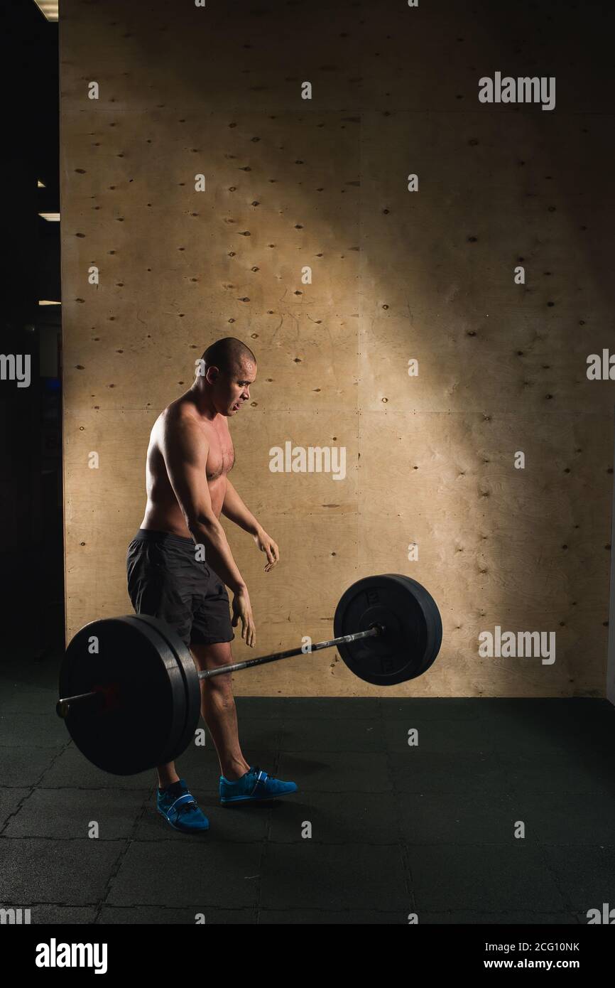 Cross fit fitness gym heavy weight lifting bar by strong man workout ...