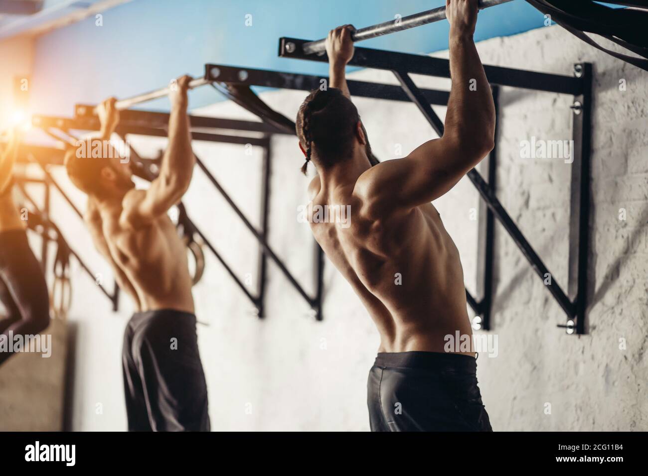 Fitness toes to bar men and woman pull-ups tree bars workout exercise ...