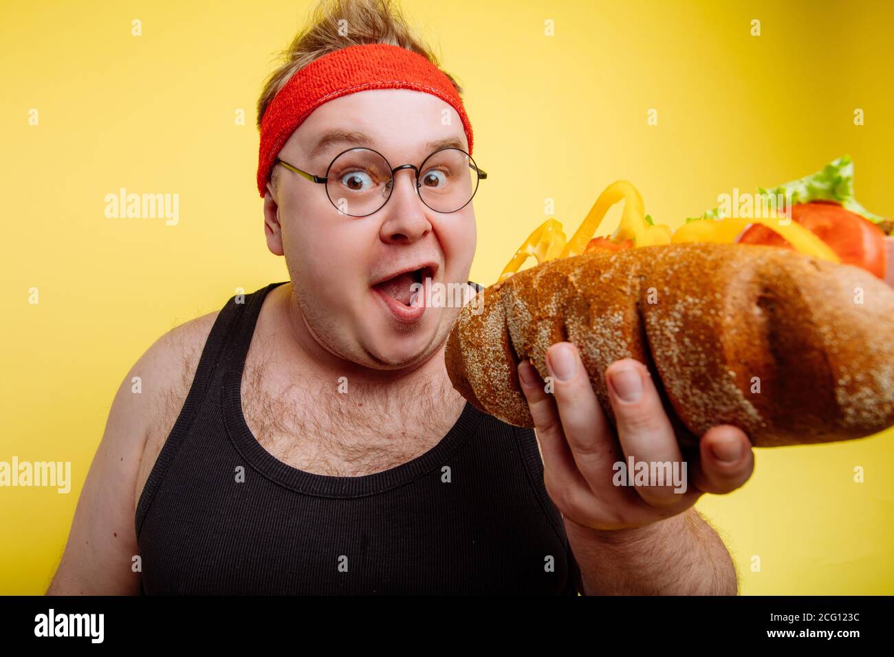 Fat funny man eating unhealthy big burger Stock Photo - Alamy