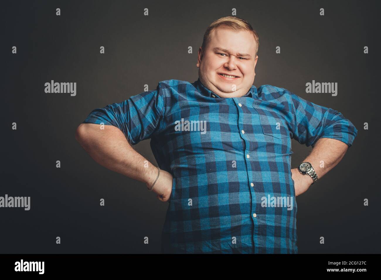 fat proud young man on black background Stock Photo - Alamy