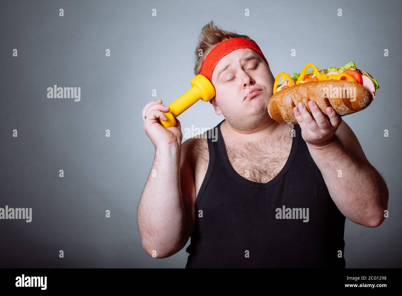 Joyful fat man is smelling sandwich and smiling Stock Photo - Alamy