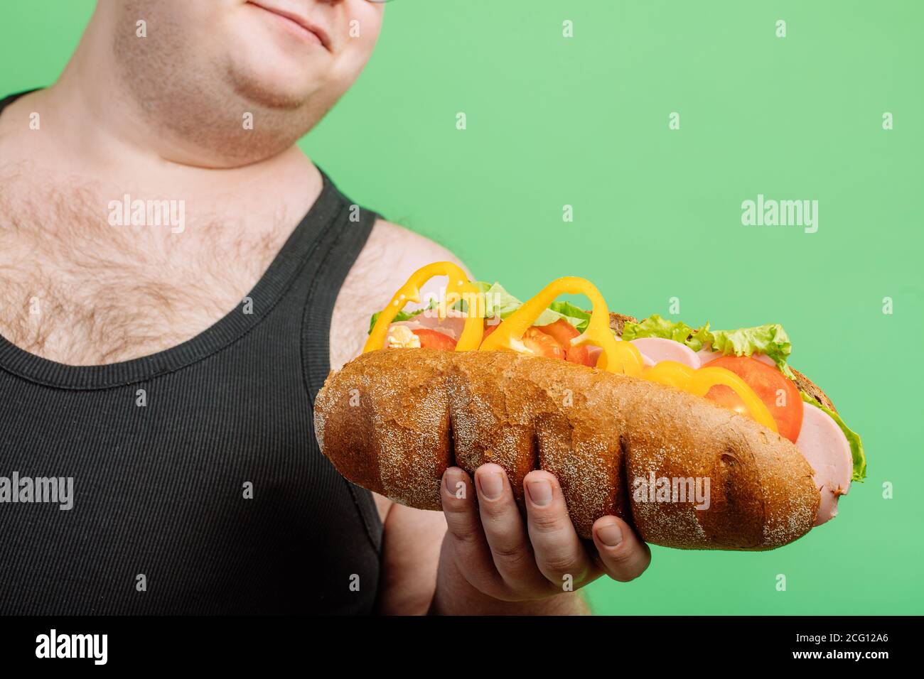 Joyful fat man is smelling sandwich and smiling Stock Photo - Alamy