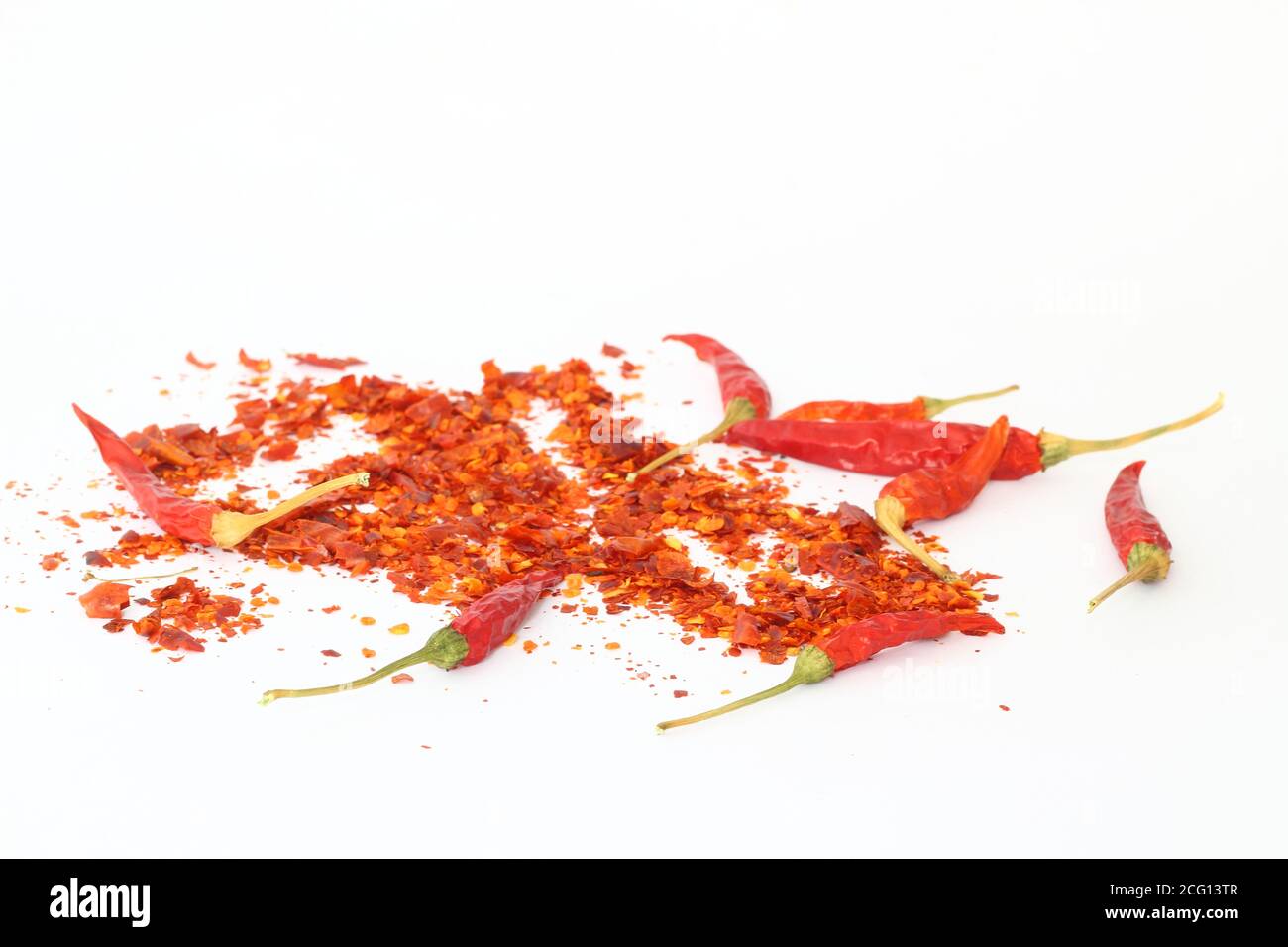 red dried crushed hot chili peppers and chili flakes or powder isolated ...