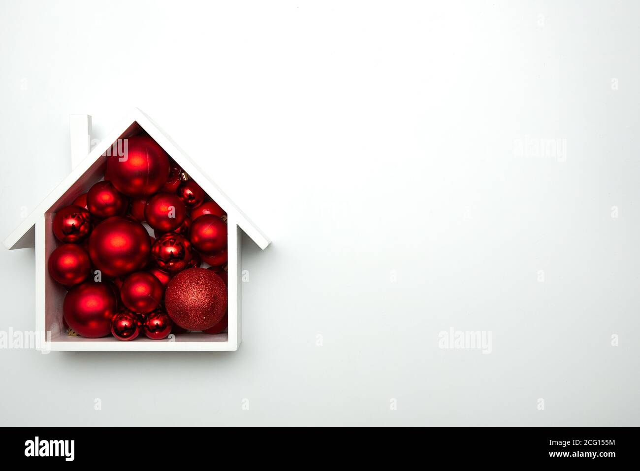 Christmas background of a festive house with Christmas tree baubles ...
