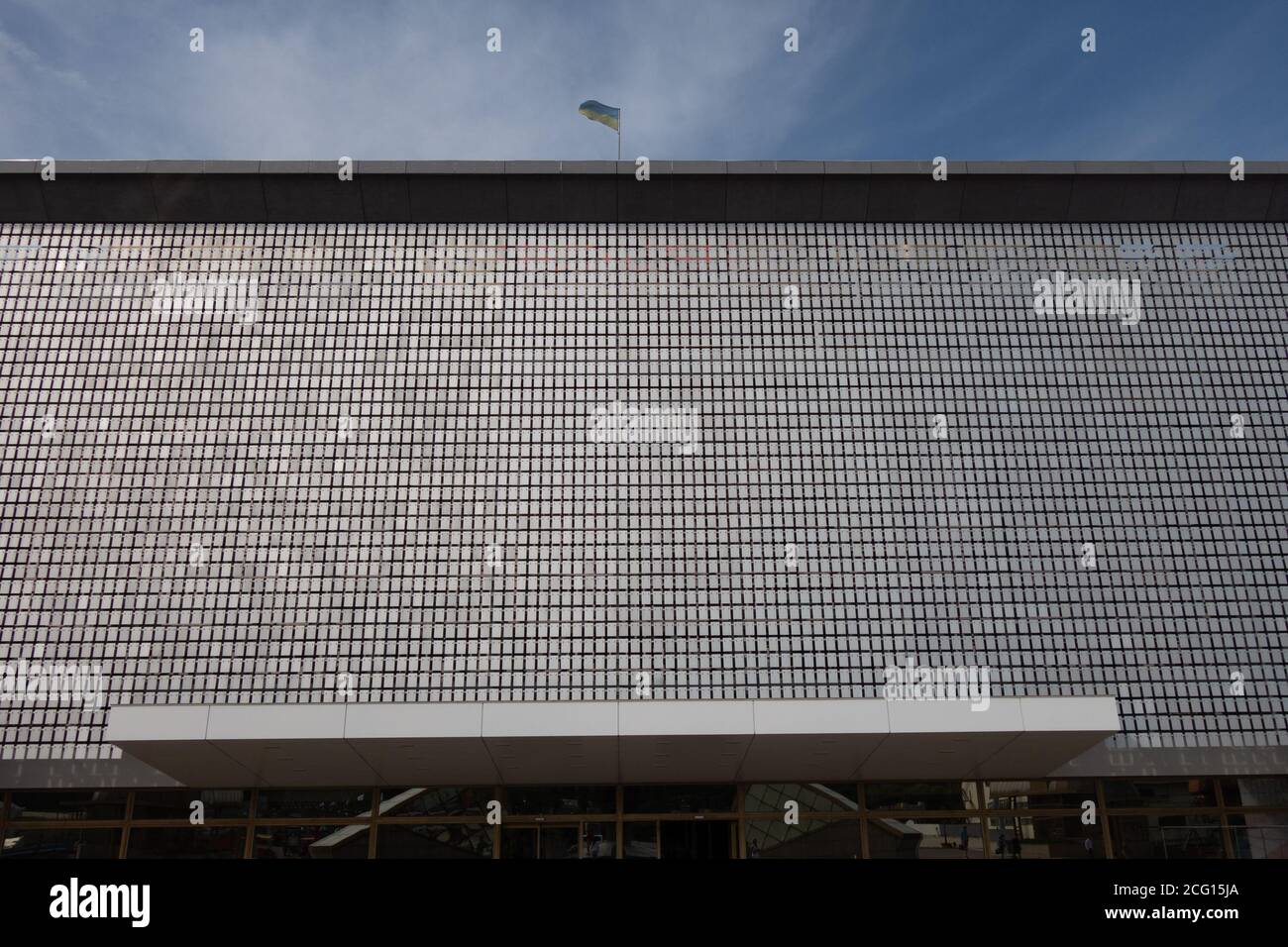 The kinetic facade of the building. Loose metal plates swing in waves ...