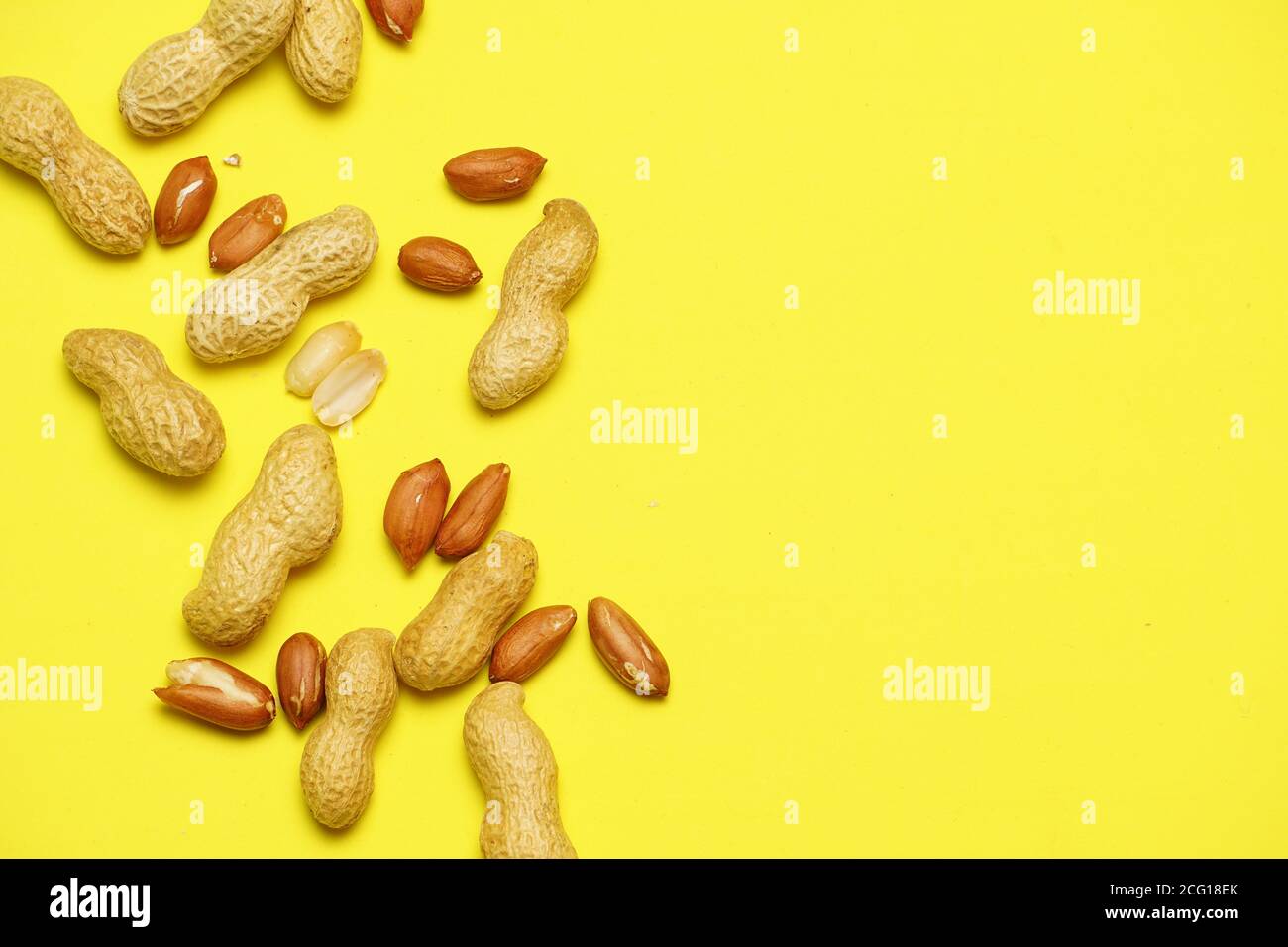peanuts on yellow background peeled and unpeeled. flat lay flat design ...