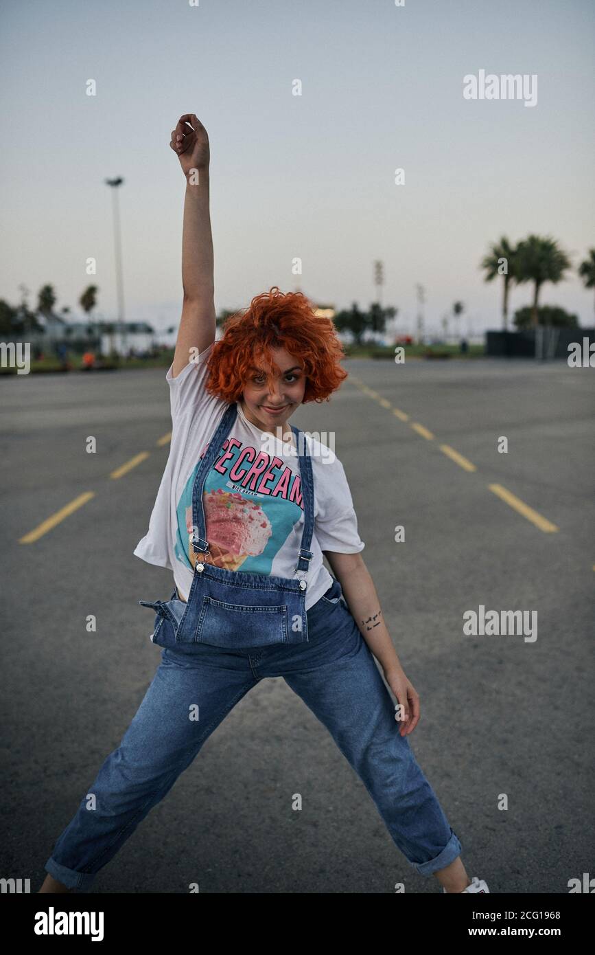 Young happy redhead girl dancing in the street Stock Photo - Alamy