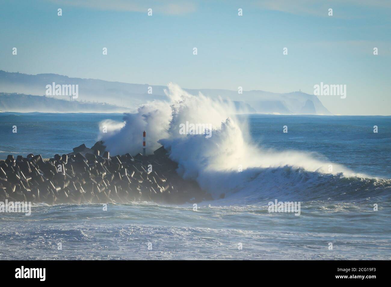 Big ocean wave hitting pier. Storm waves Stock Photo - Alamy
