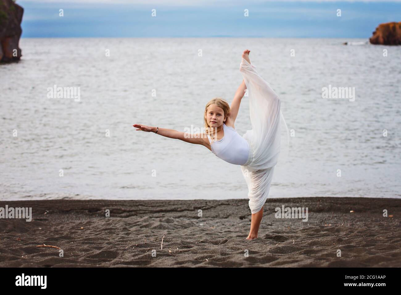 Young Blond Girl Dancing on Beach Stock Photo - Alamy