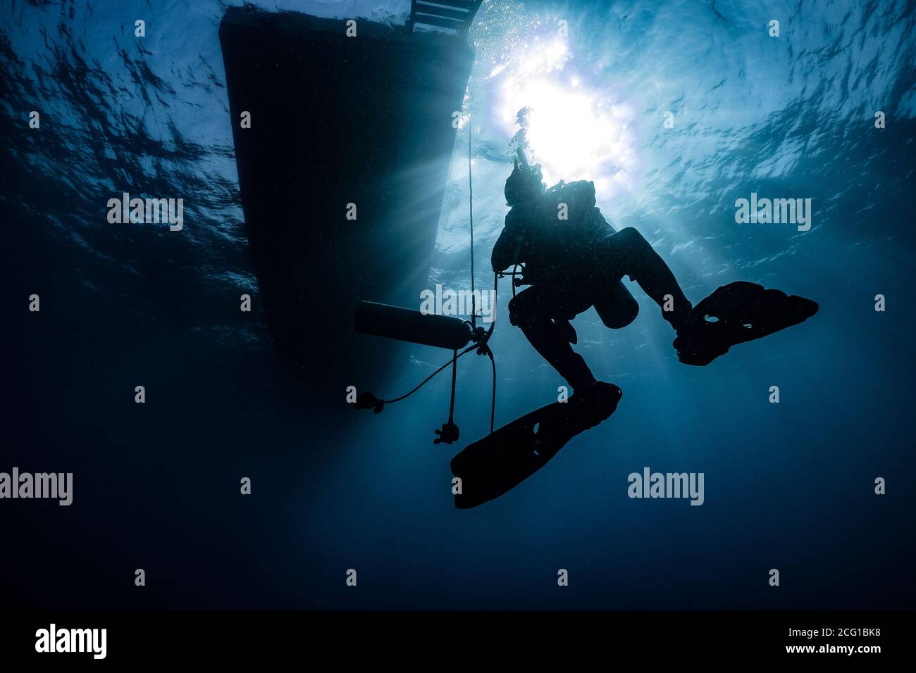 silhouette of scuba diver underwater in ocean under boat Stock Photo ...