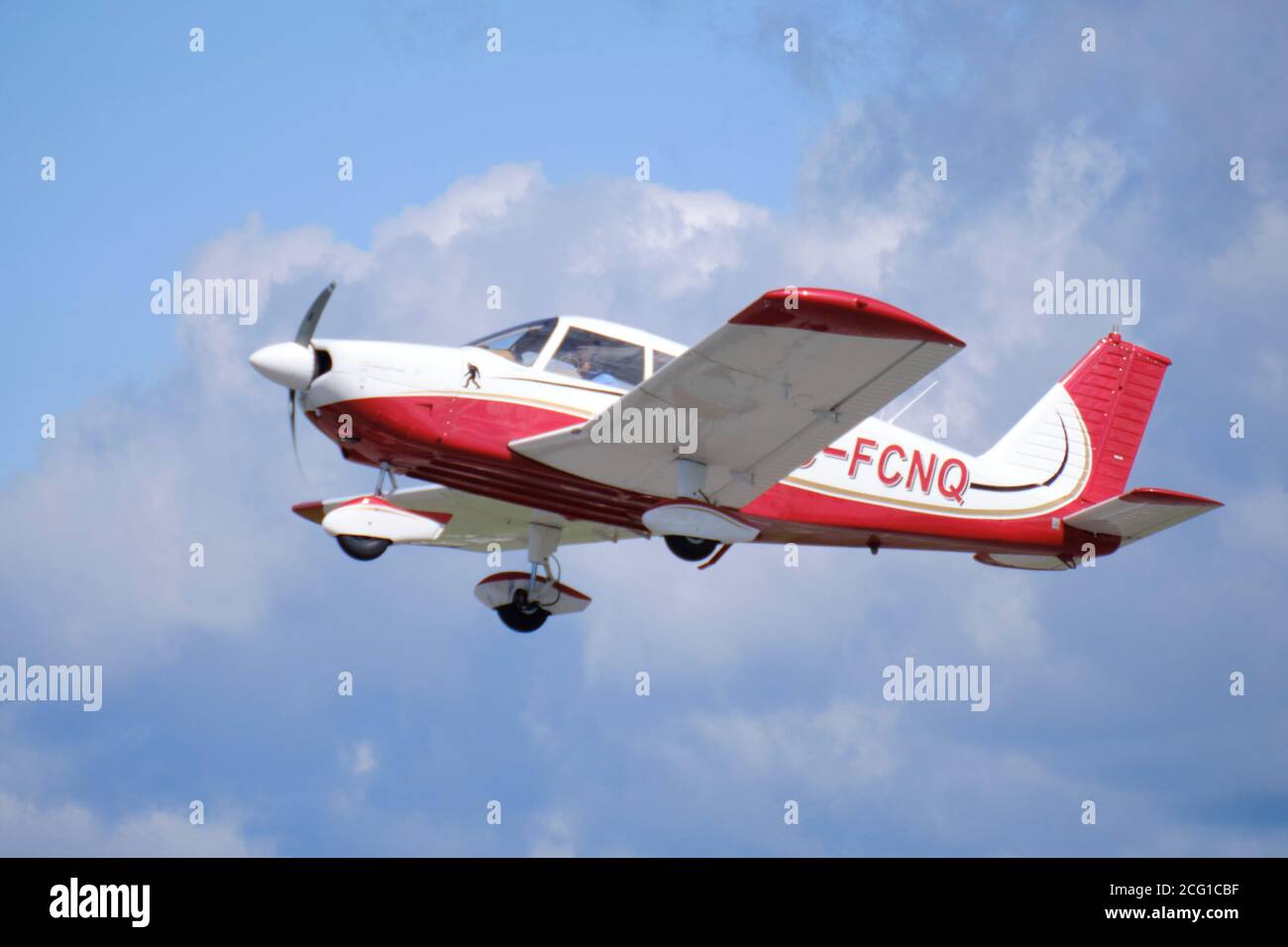 White and red Piper PA-28-180 Cherokee plane in assention after taking ...