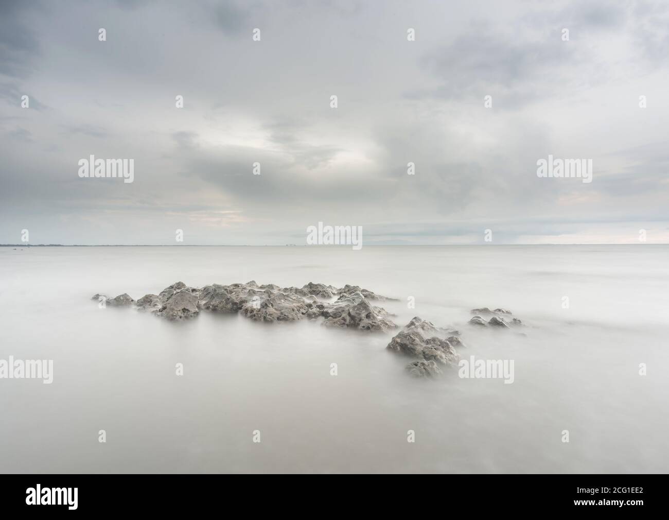 cluster of rocks on the beach taken in long exposure Stock Photo - Alamy