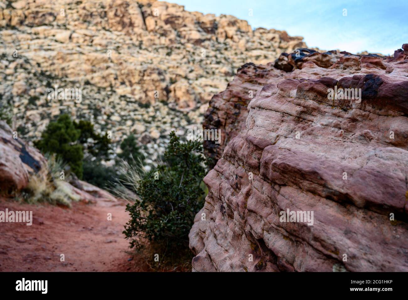 Rock outcrop along hiking trail overlooking mountains at Red Rock ...