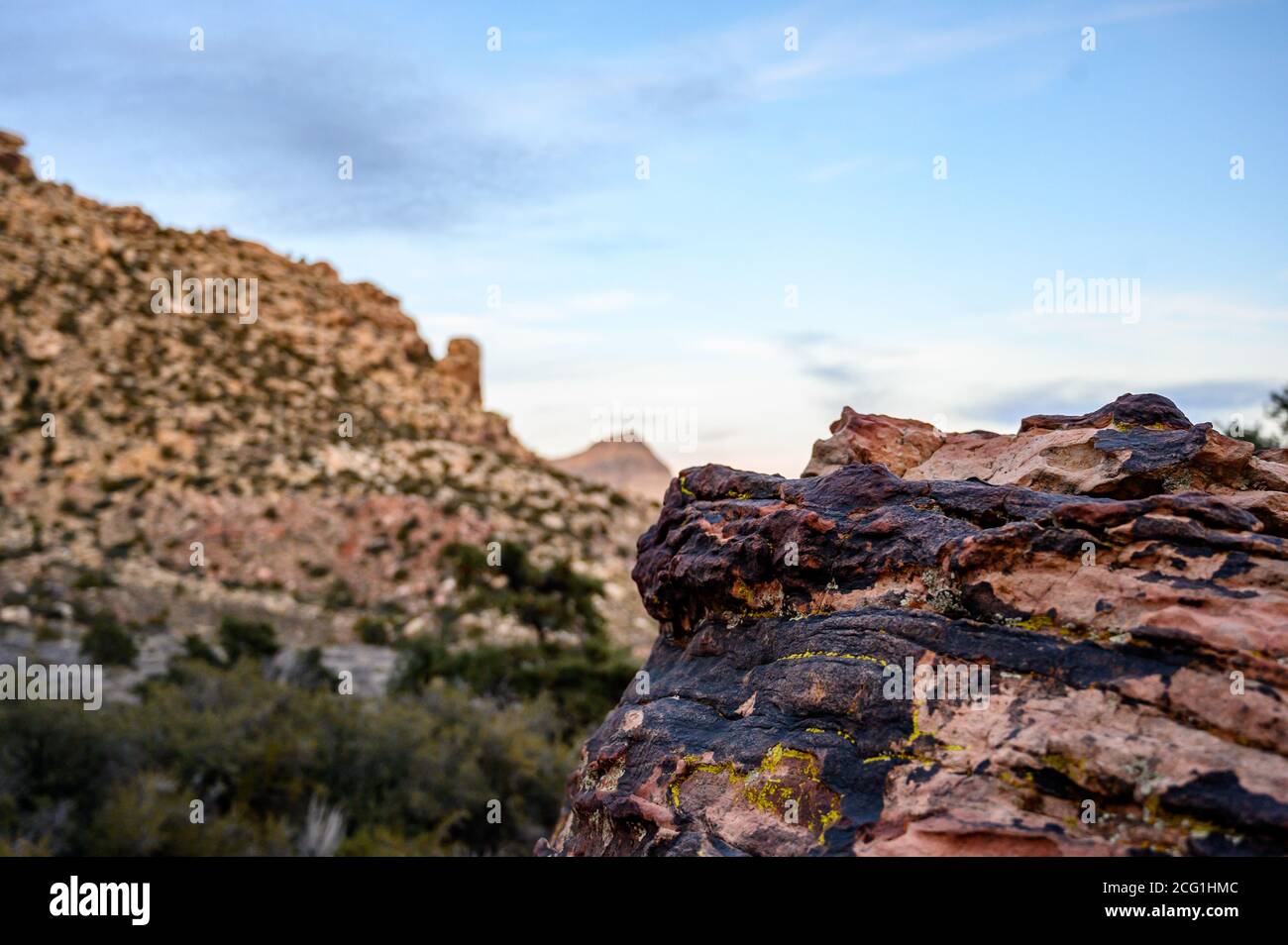 Rock outcrop along hiking trail overlooking mountains at Red Rock ...
