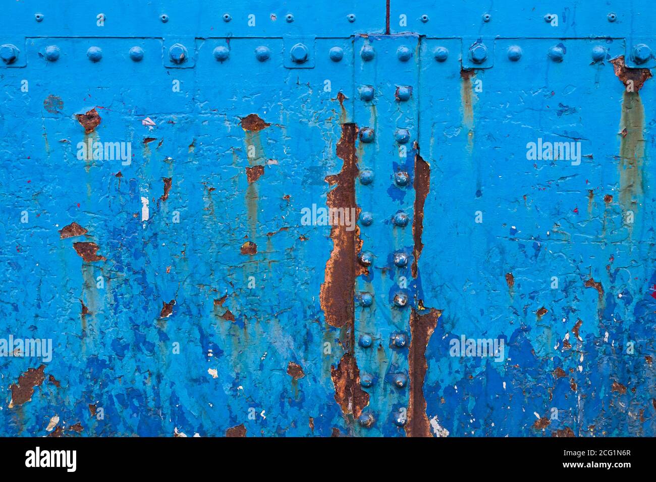 Old flaking blue paint on a railway bridge, Southall, London, UK. 18 ...