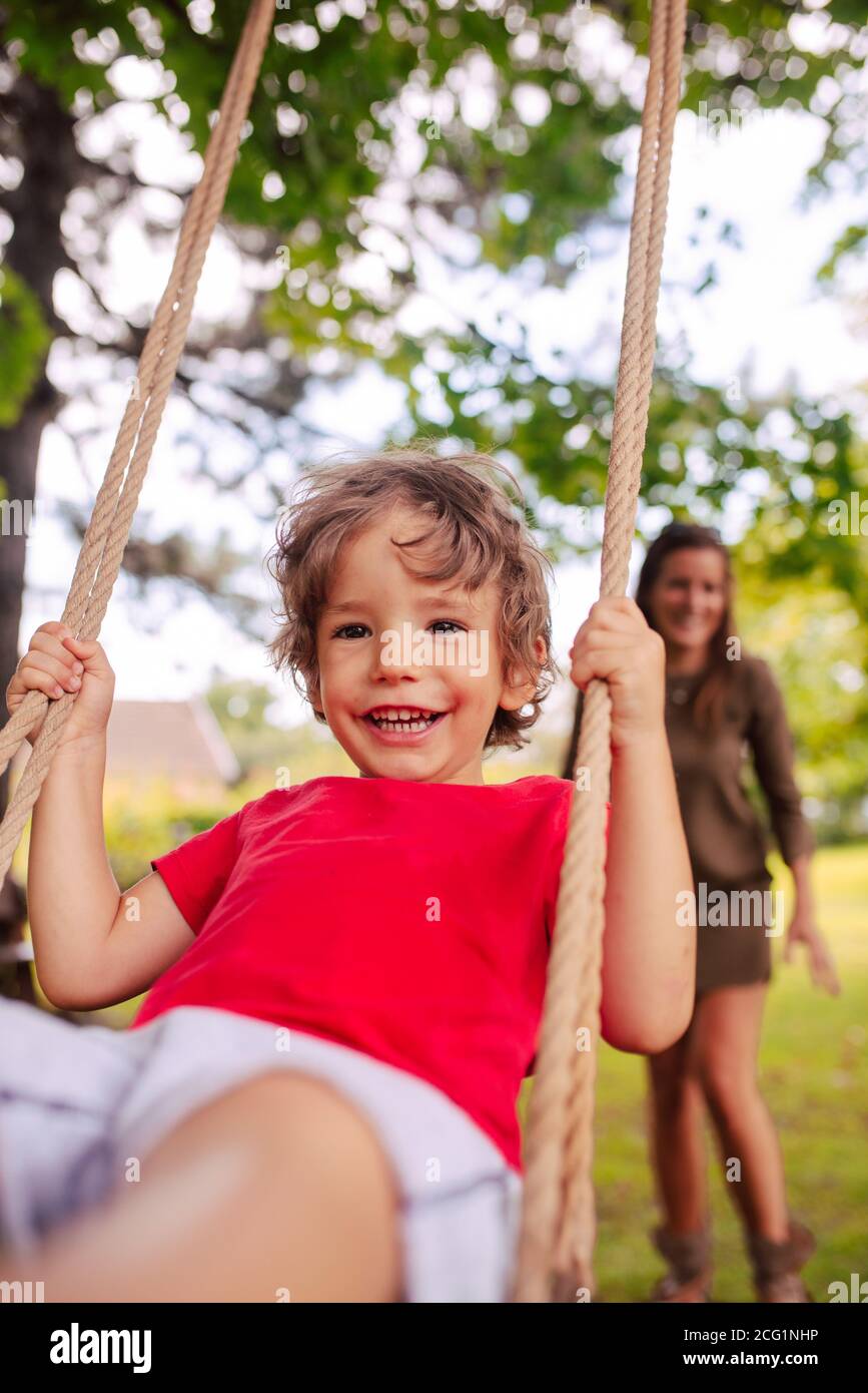 Boy swing tree forest hi-res stock photography and images - Alamy