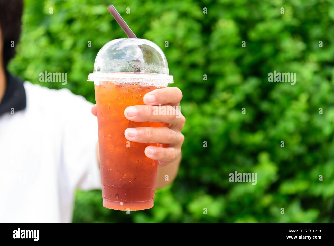 The man hold ice tea for you Stock Photo - Alamy
